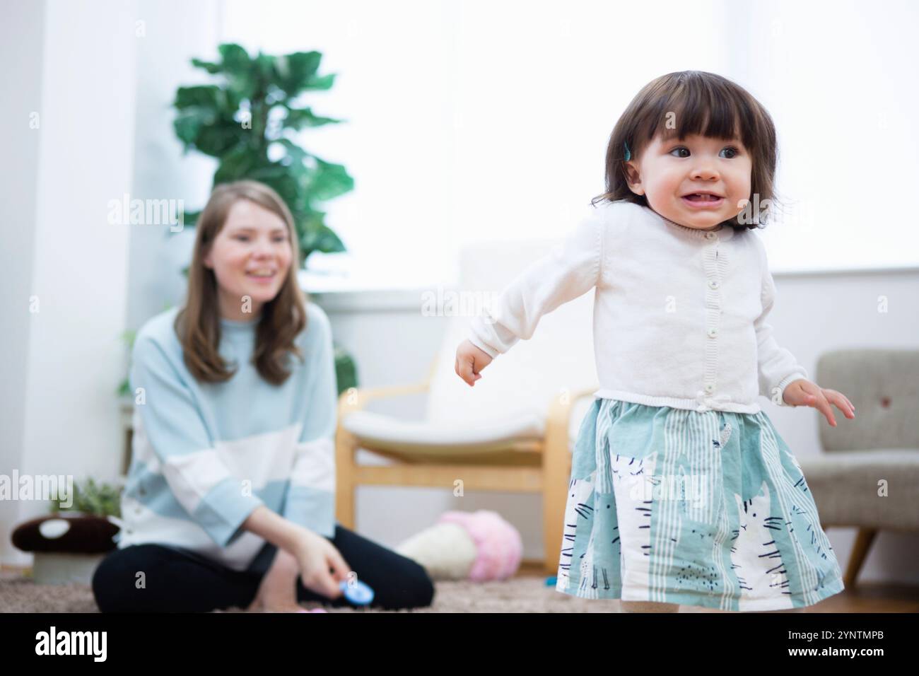 Parent and child playing in room Stock Photo - Alamy
