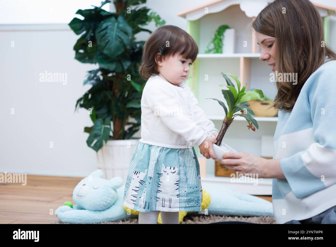 Parent and child playing in room Stock Photo - Alamy