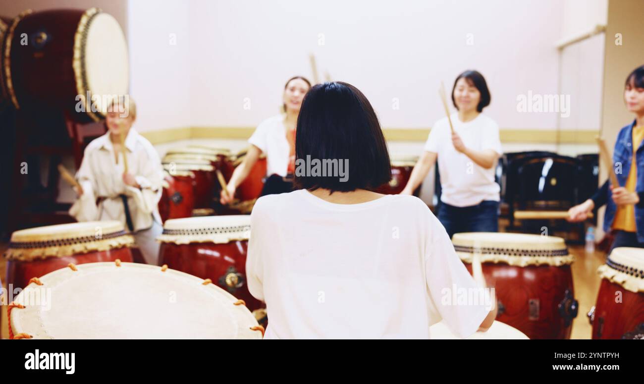 Japanese, drums and people in practice for music on instrument for ...