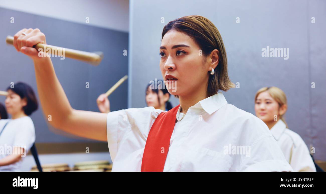 Japanese, drums and woman in practice for music on instrument for ...