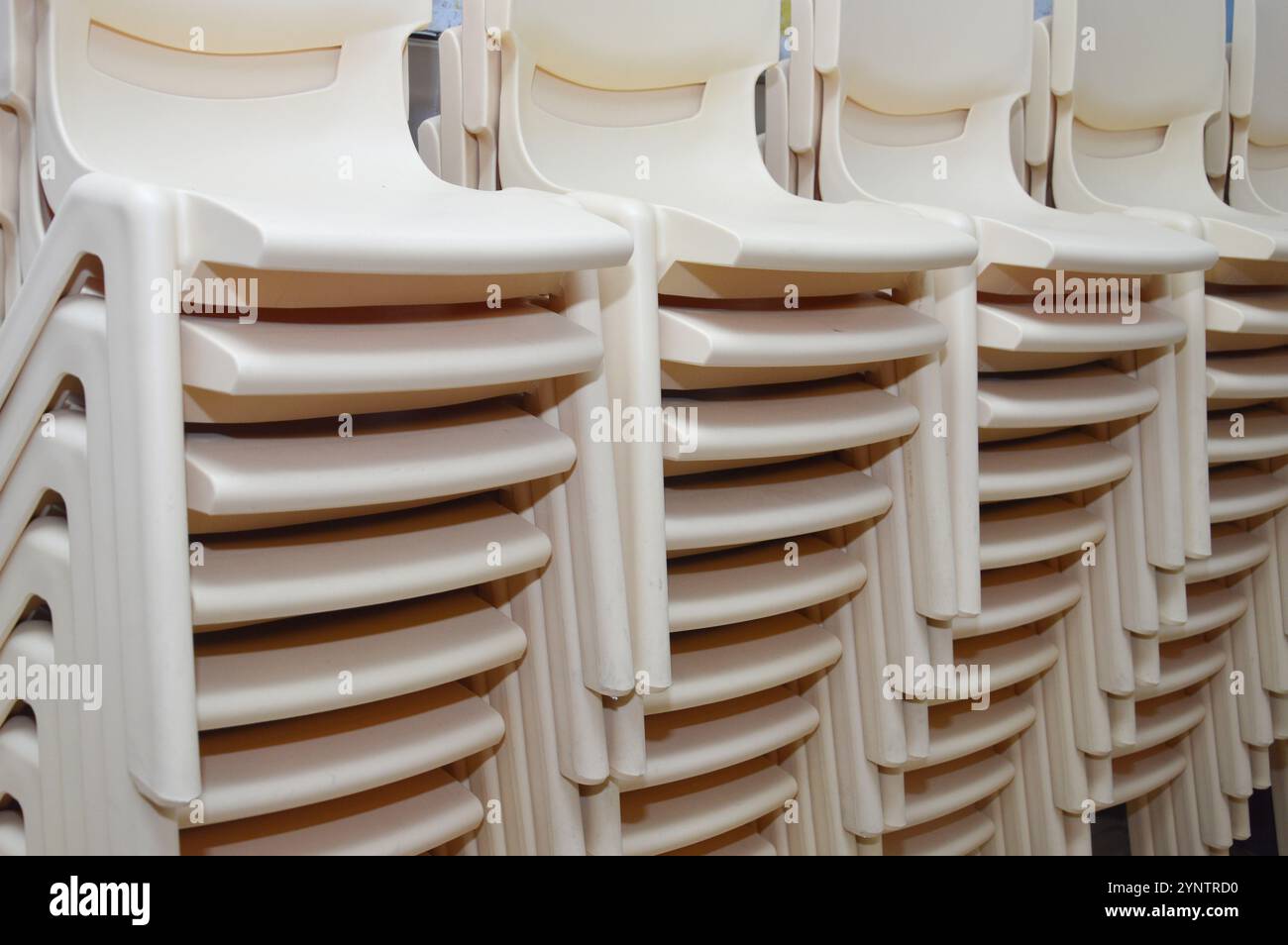 pile plastic chair background Stock Photo - Alamy