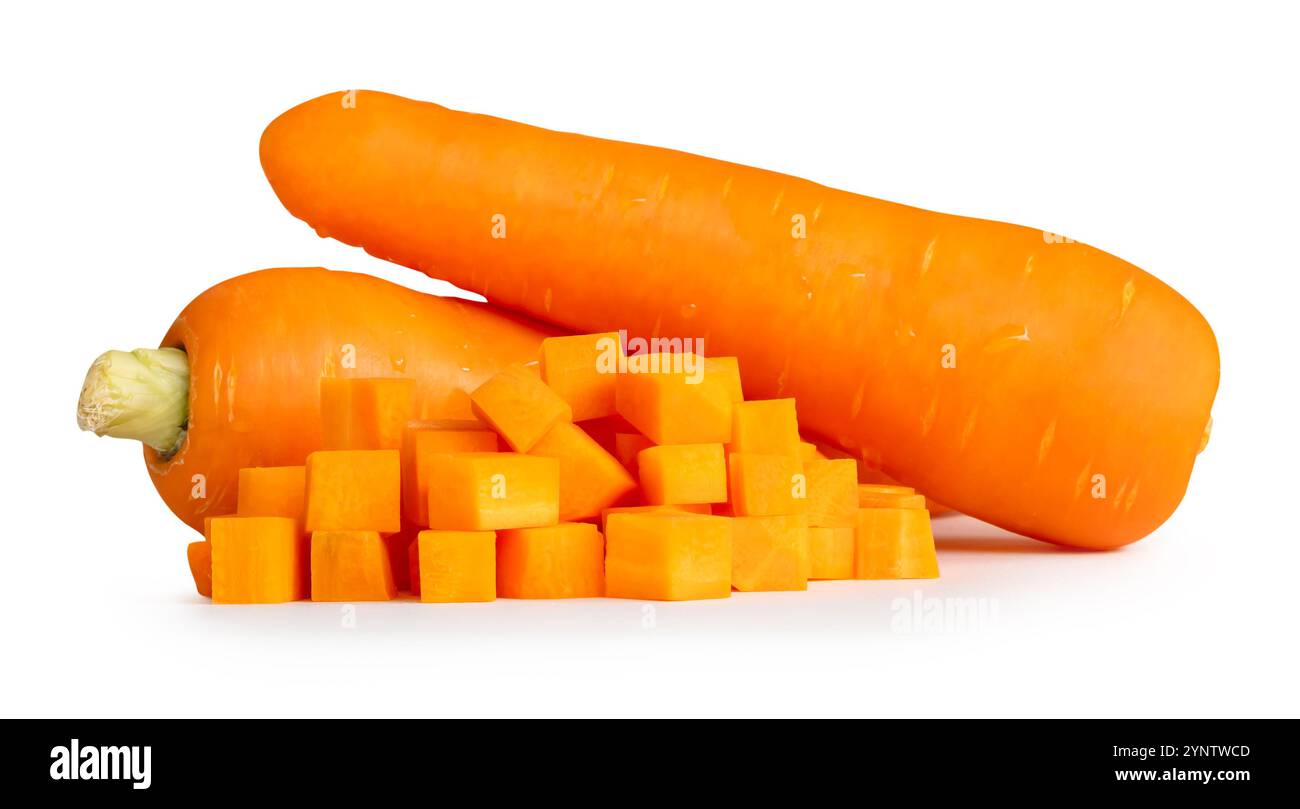Side view of orange carrot roots with slices or pieces in cube shape in ...