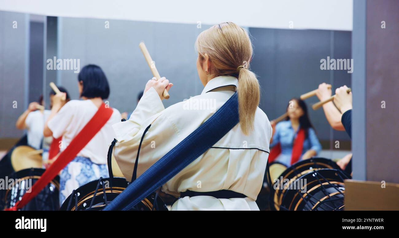 Japanese, back and people with drums for music on instrument for ...