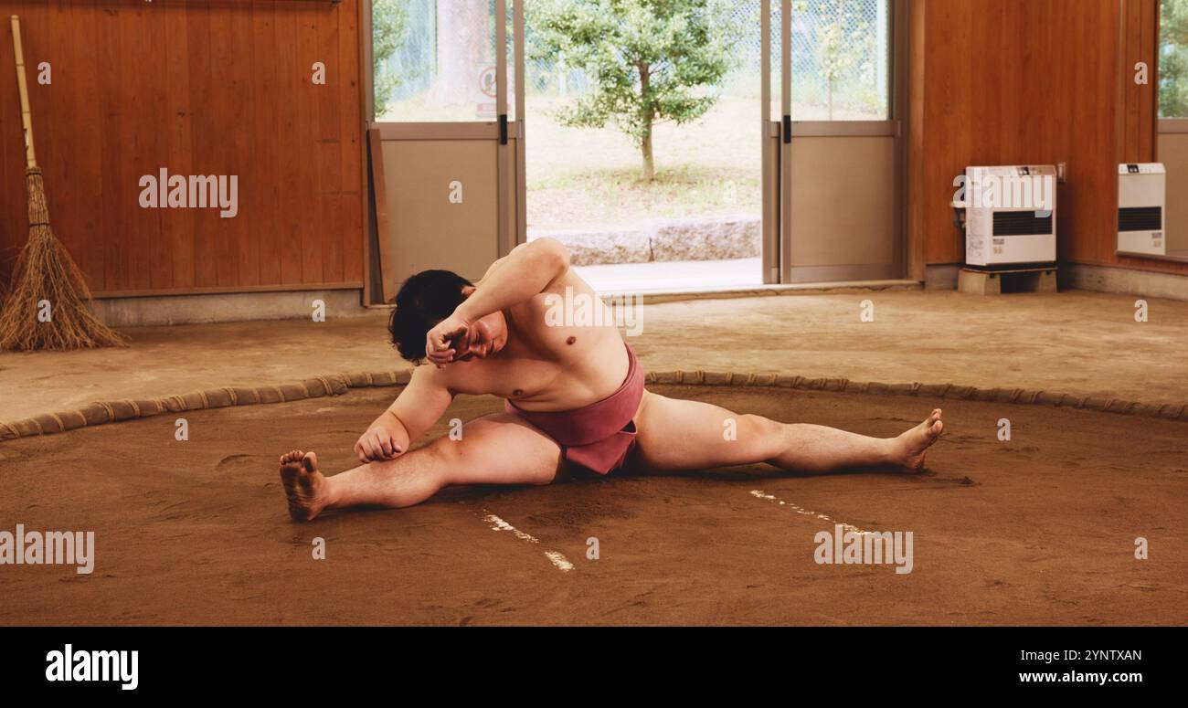Athlete, training and exercise for sumo, fitness and splits with preparation, stretching and ...