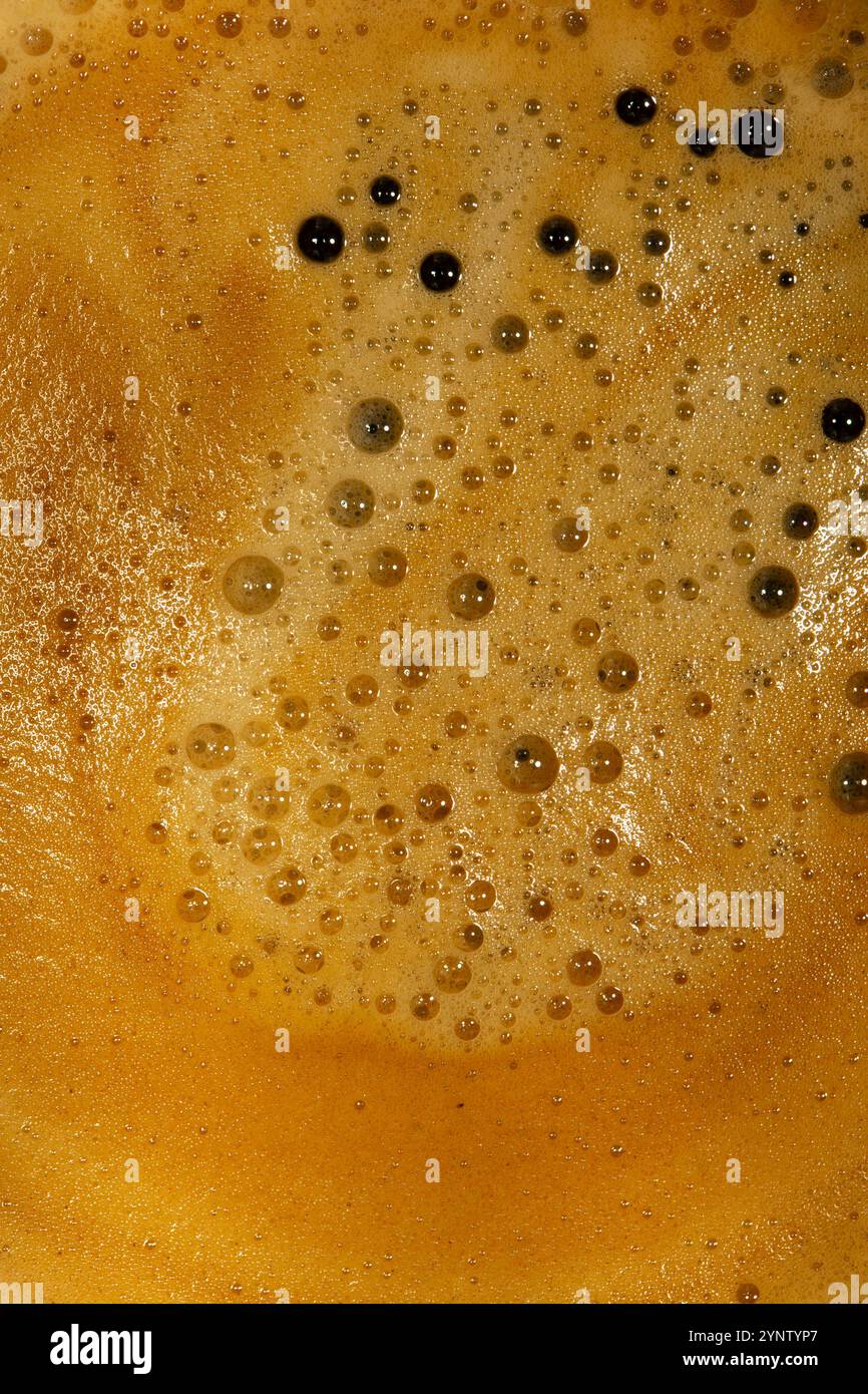Frothy black americano coffee background backdrop made in a coffee ...