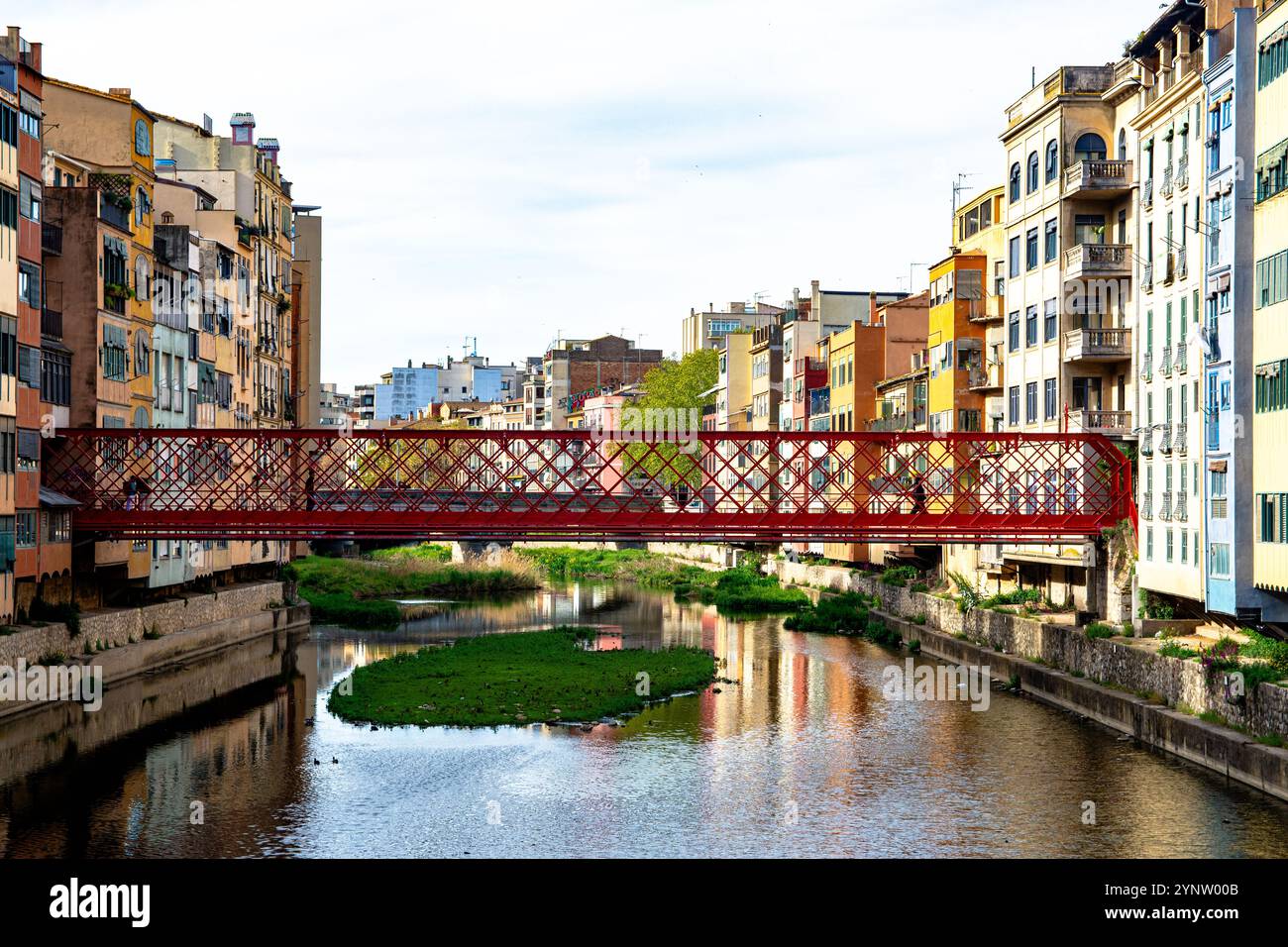 Colorful buildings along Onyar River with red bridge Stock Photo - Alamy