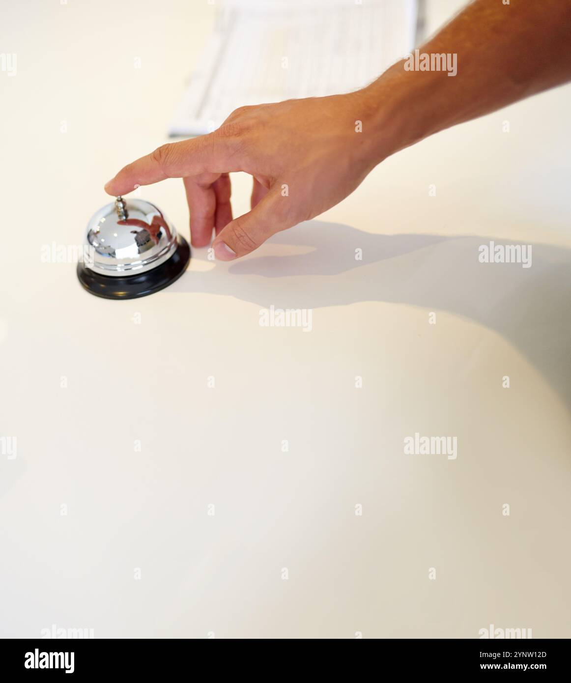 Hand, person and ring bell on counter, hotel concierge and ready to ...