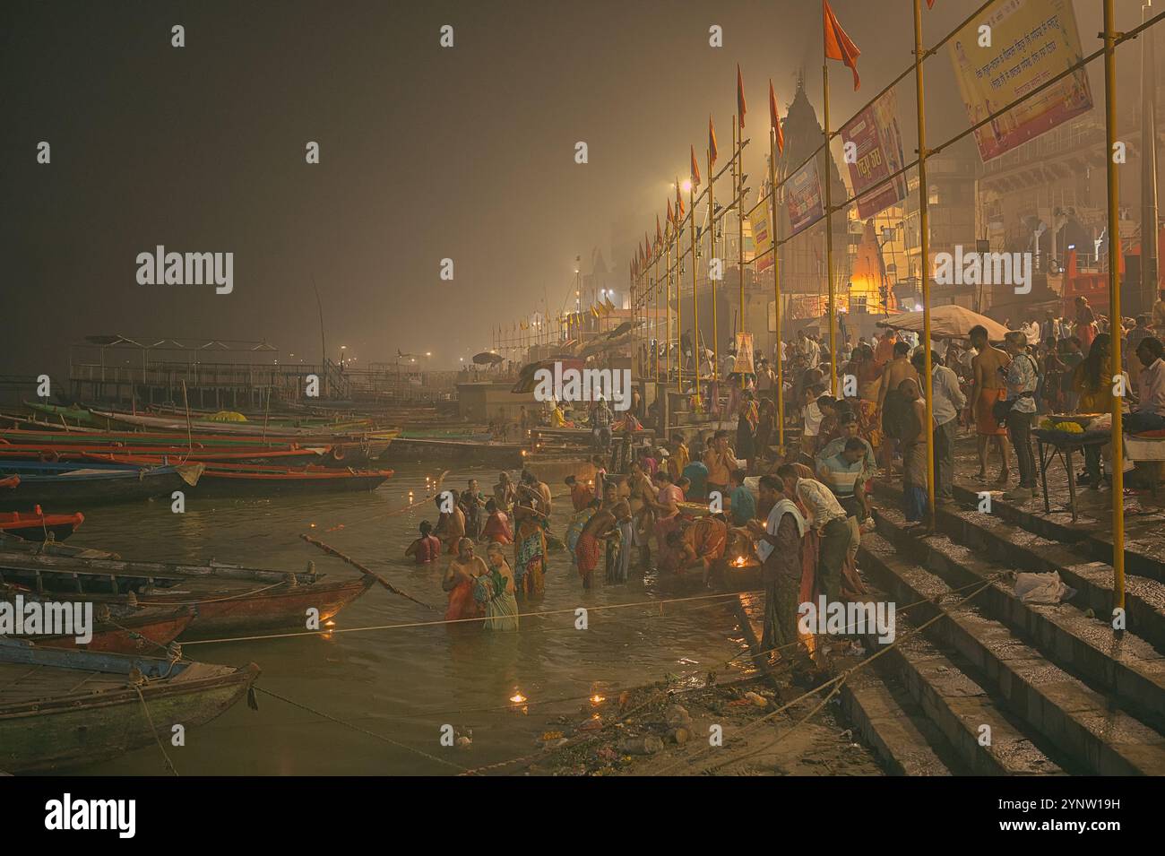 A pre-dawn photo of Hindu pilgrims bathing in the sacred waters of the ...