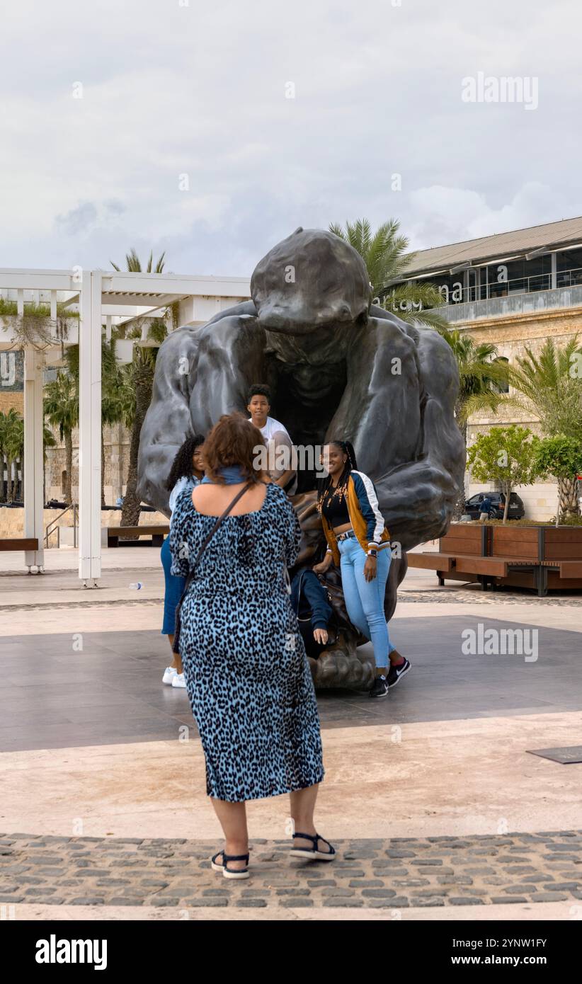Tourist taking a photograph of El Zulo bronze sculpture at the Port ...