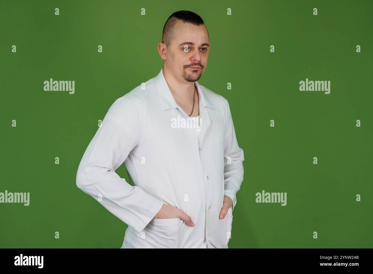 Male Medic in White Lab Coat Posing Against a Green Background Stock ...