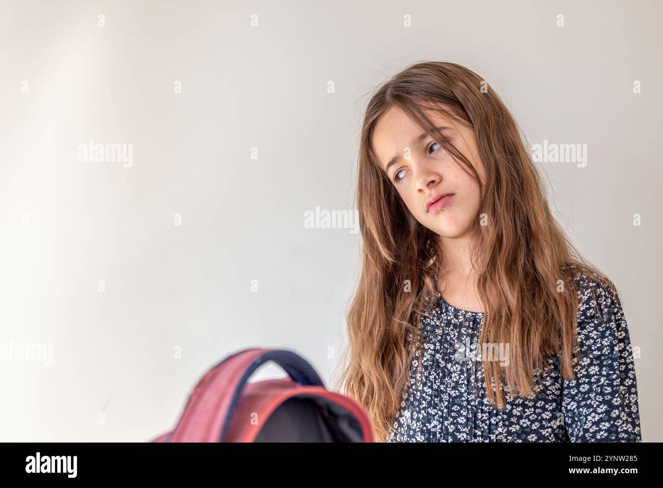 A tired girl is going to school. Girl and school life Stock Photo - Alamy