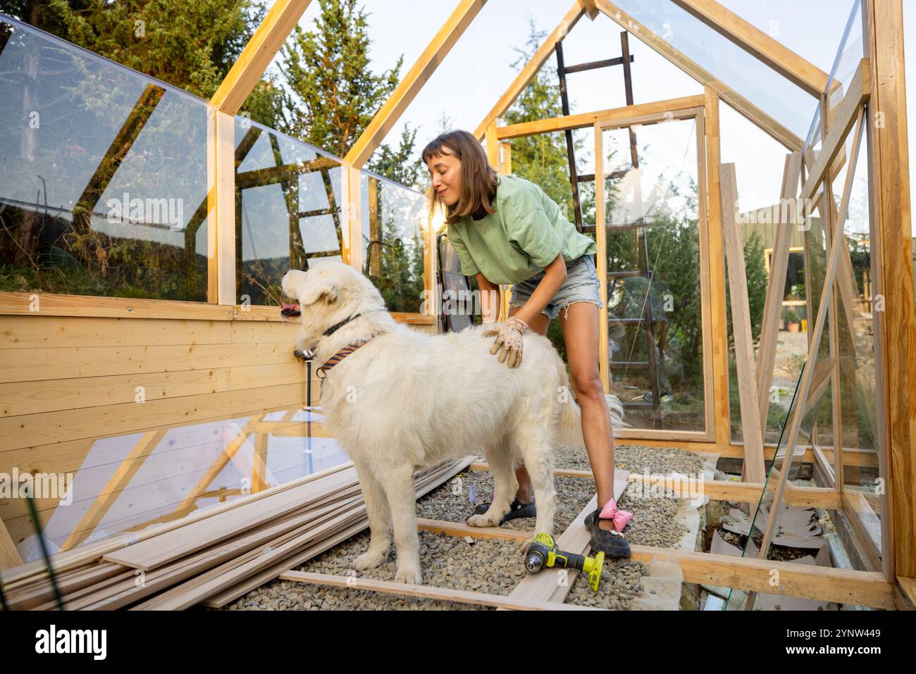 Female Carpenter Playing with Her Dog Stock Photo - Alamy