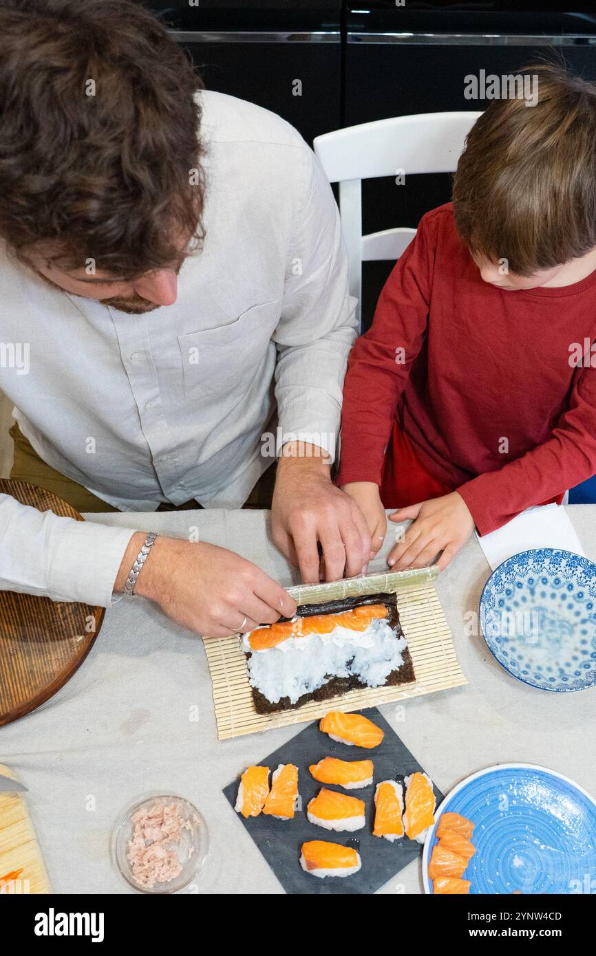 Caucasian father and son preparing sushi at home together Stock Photo ...