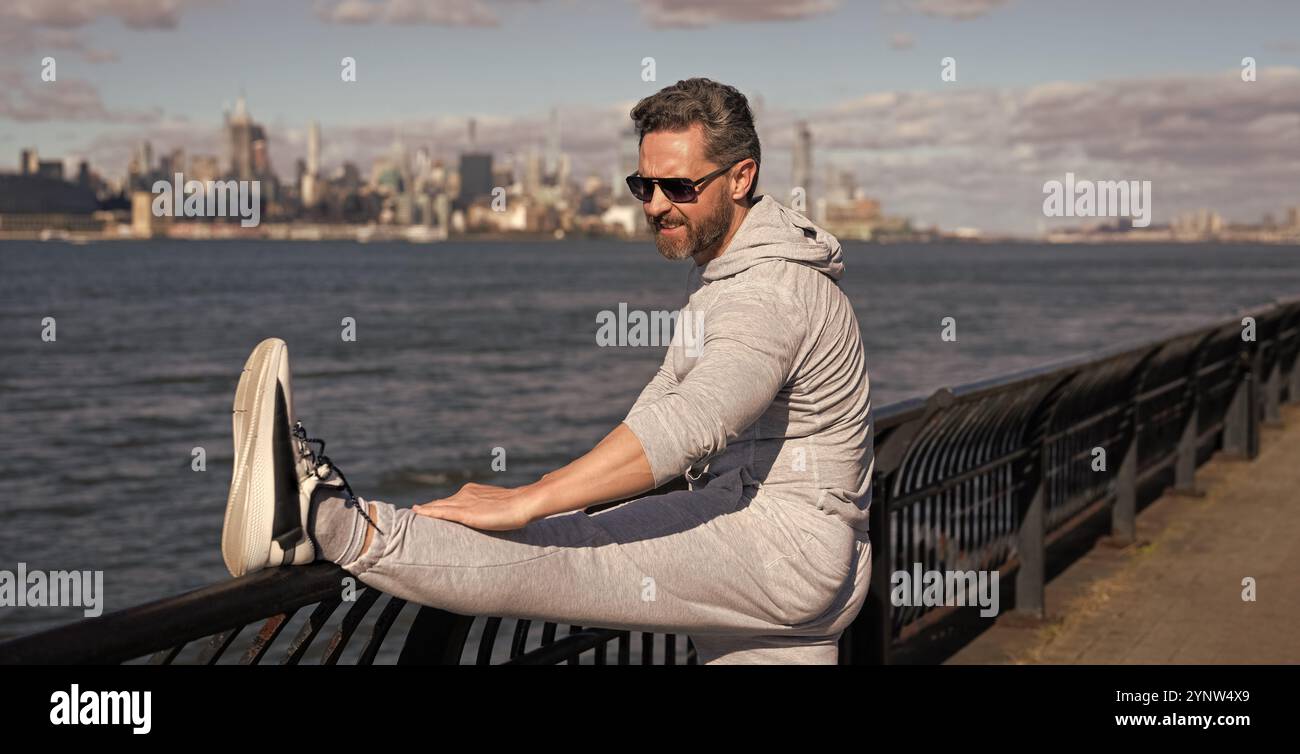 Stretching routine of athlete outdoor. Athlete stretching his muscles ...