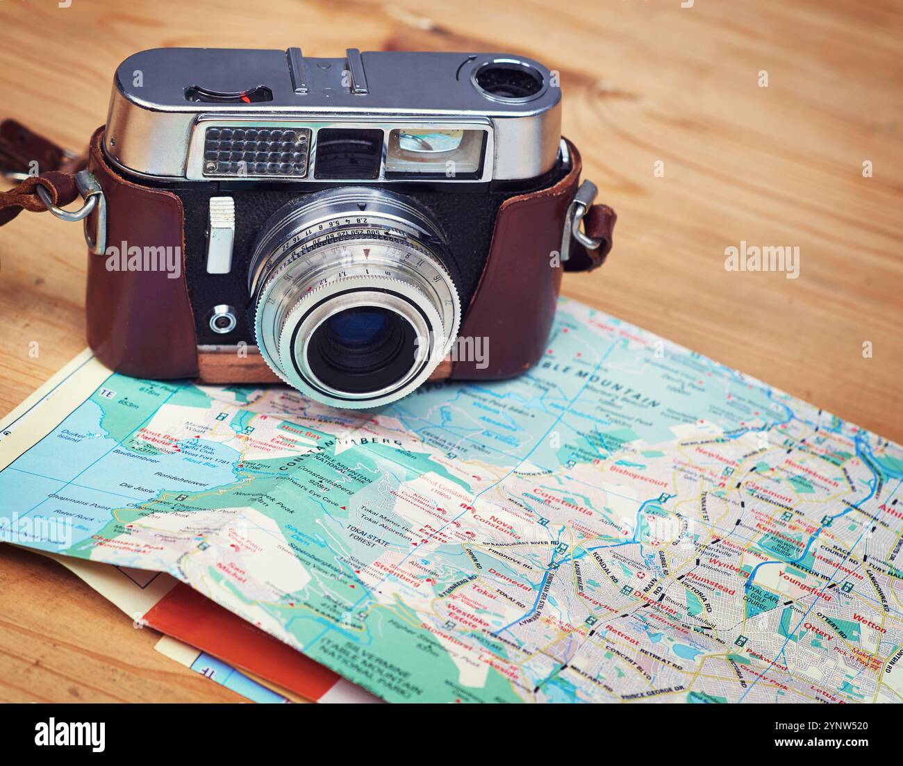 Holiday, map and photography with camera on table for itinerary ...