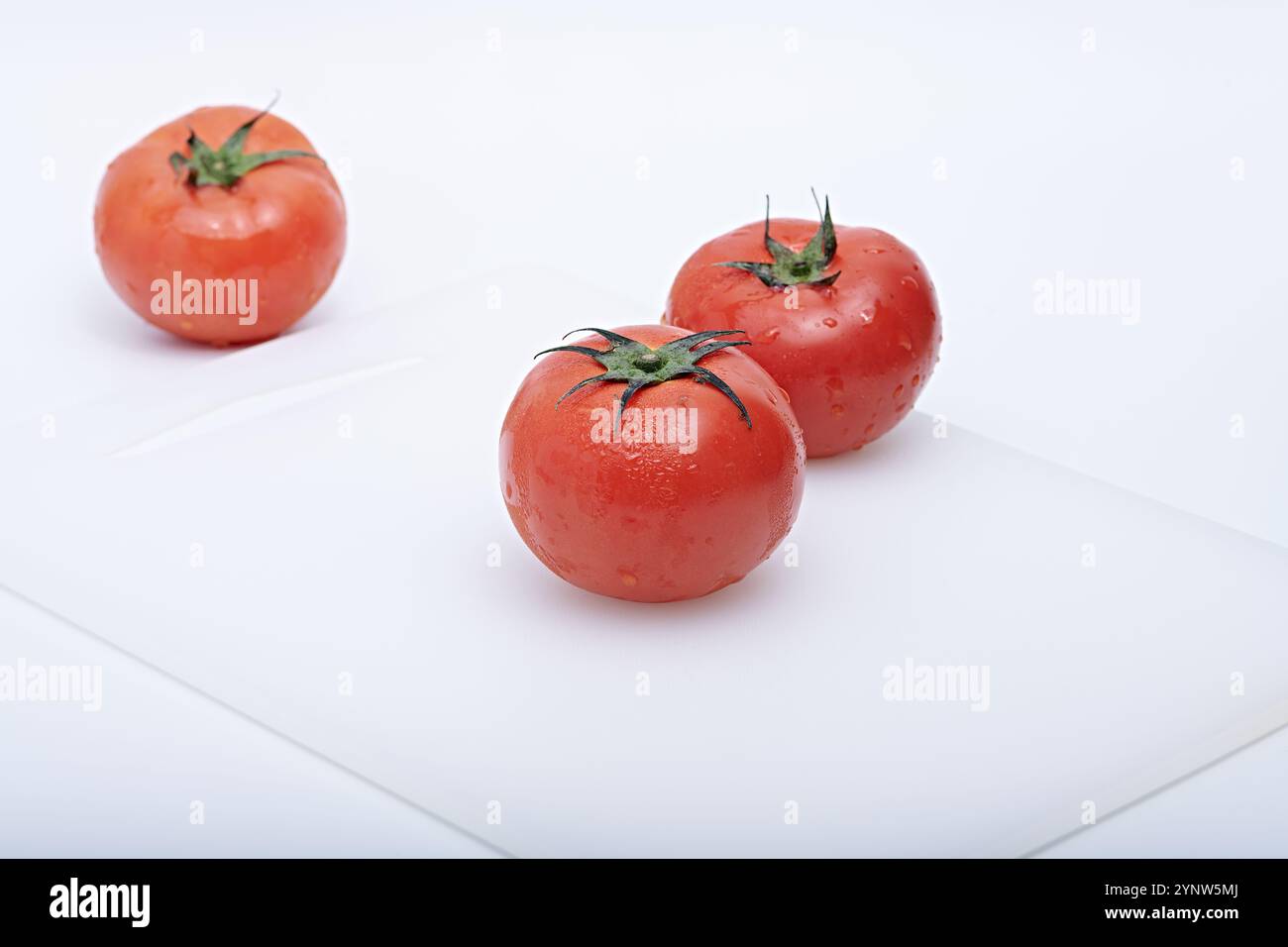 Healthy vegetable tomatoes photographed on a white background and base ...
