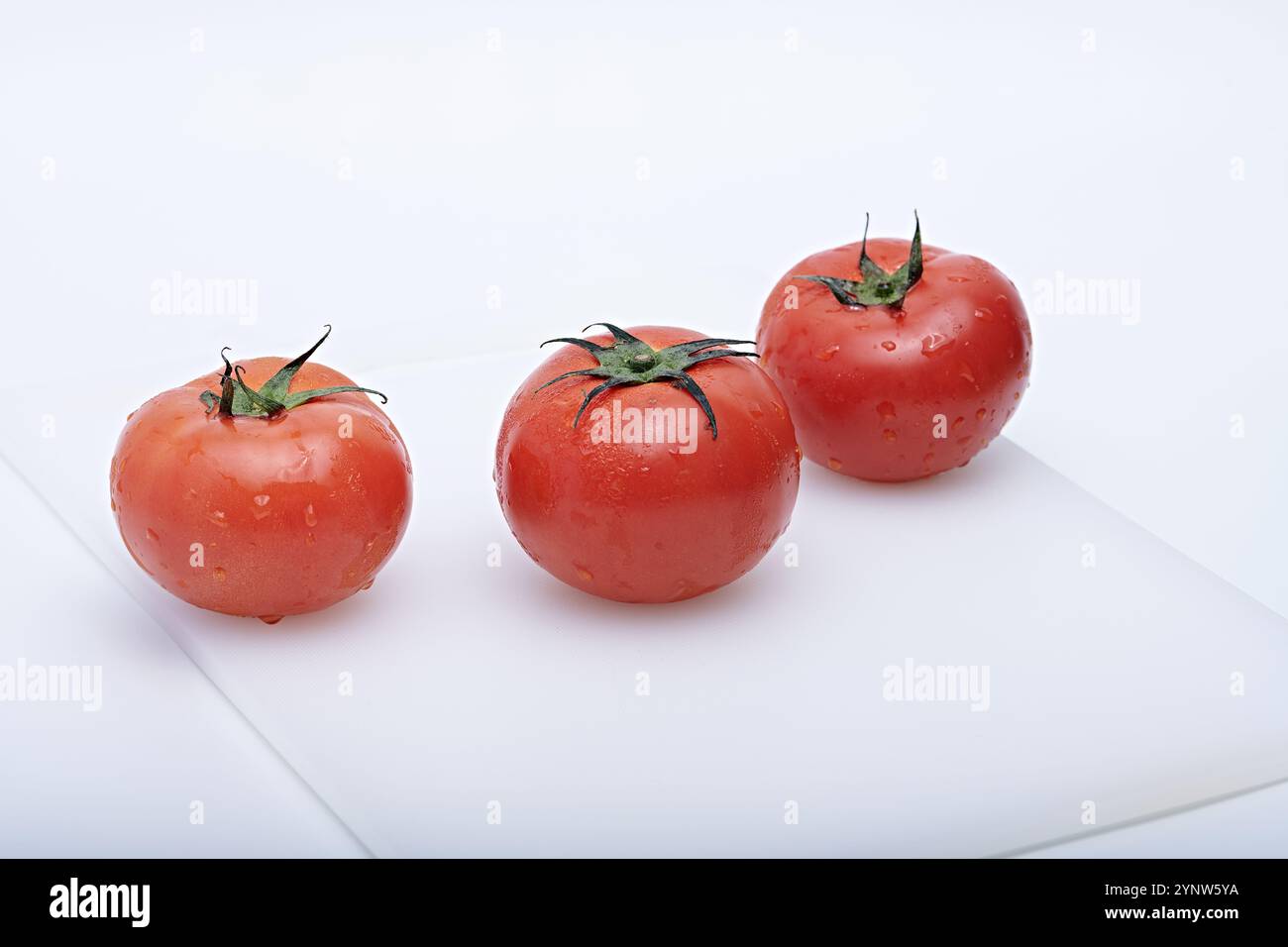 Healthy vegetable tomatoes photographed on a white background and base ...