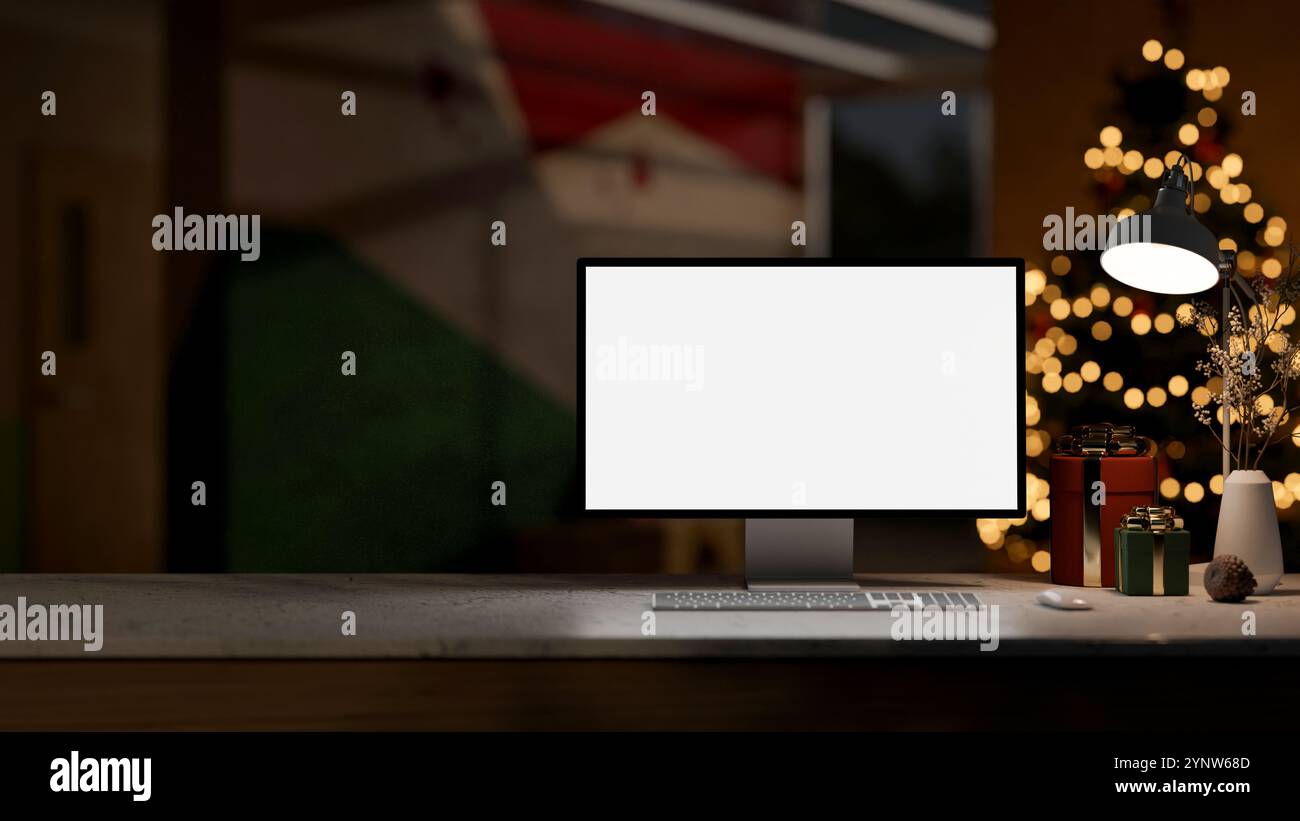 A computer with a white screen mockup, gift boxes and a table lamp on a ...
