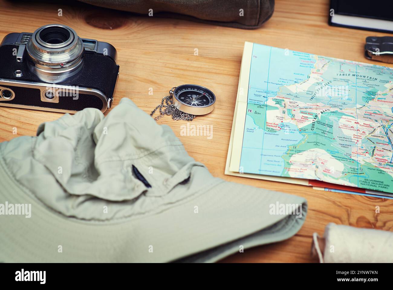 Vacation, map and compass with camera on table for itinerary schedule ...