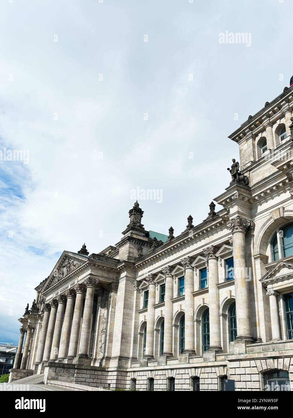 A grand neoclassical Reichstag building with majestic columns and ...