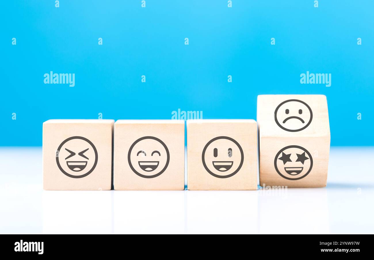 Wooden blocks displaying a sad face transitioning to a happy face ...