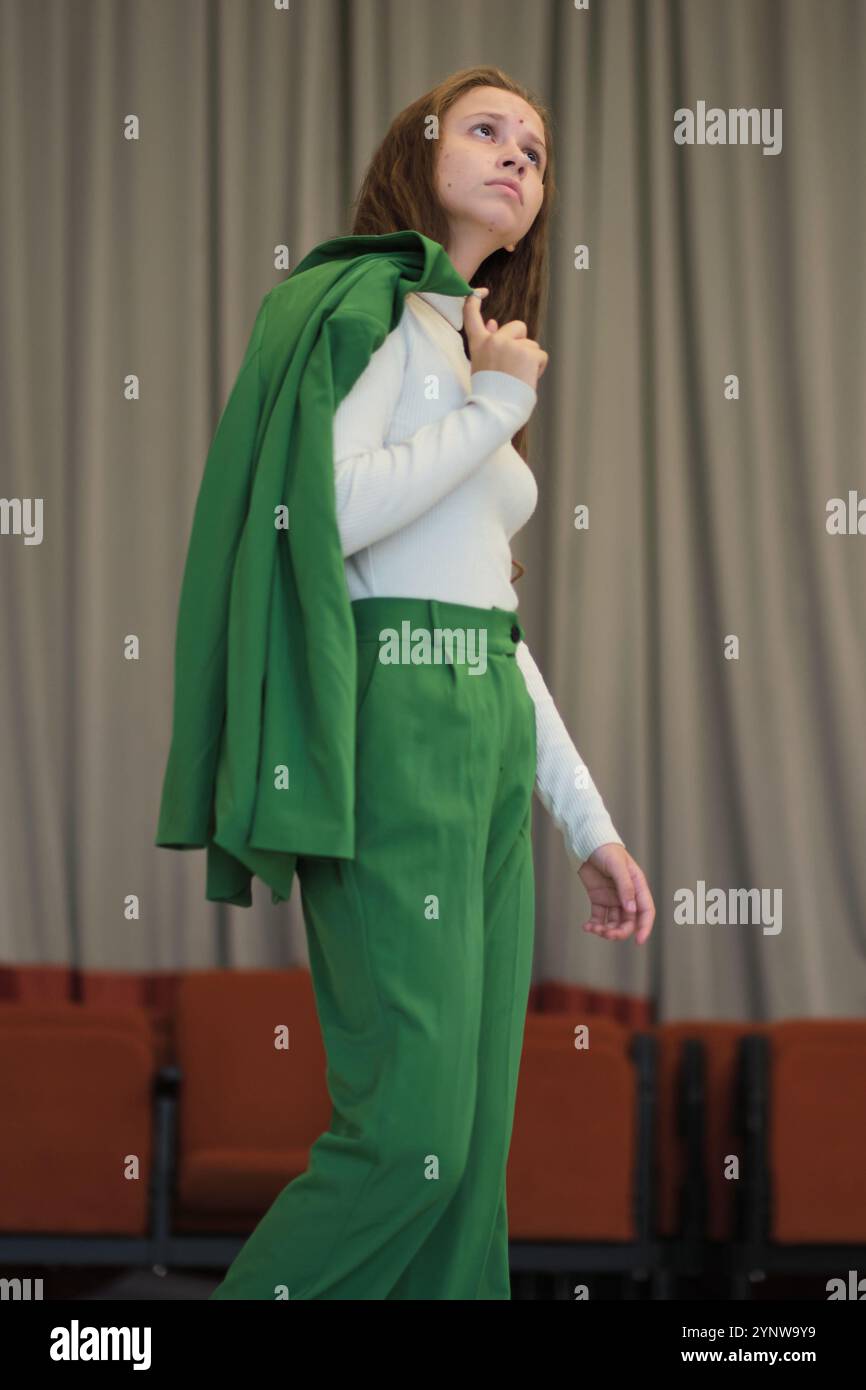 A stylish woman carrying her jacket over her shoulder, exuding elegance ...