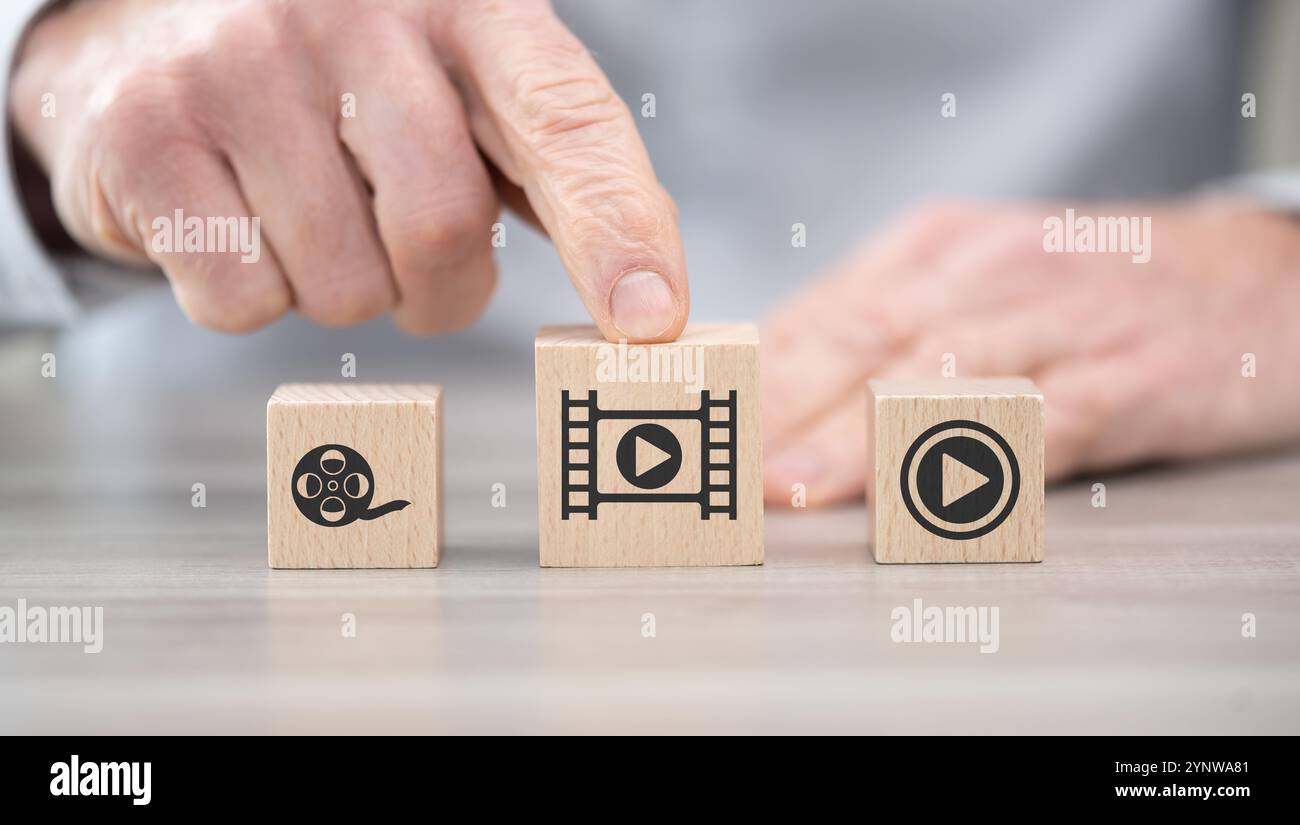 Wooden blocks with symbol of cinema concept Stock Photo - Alamy