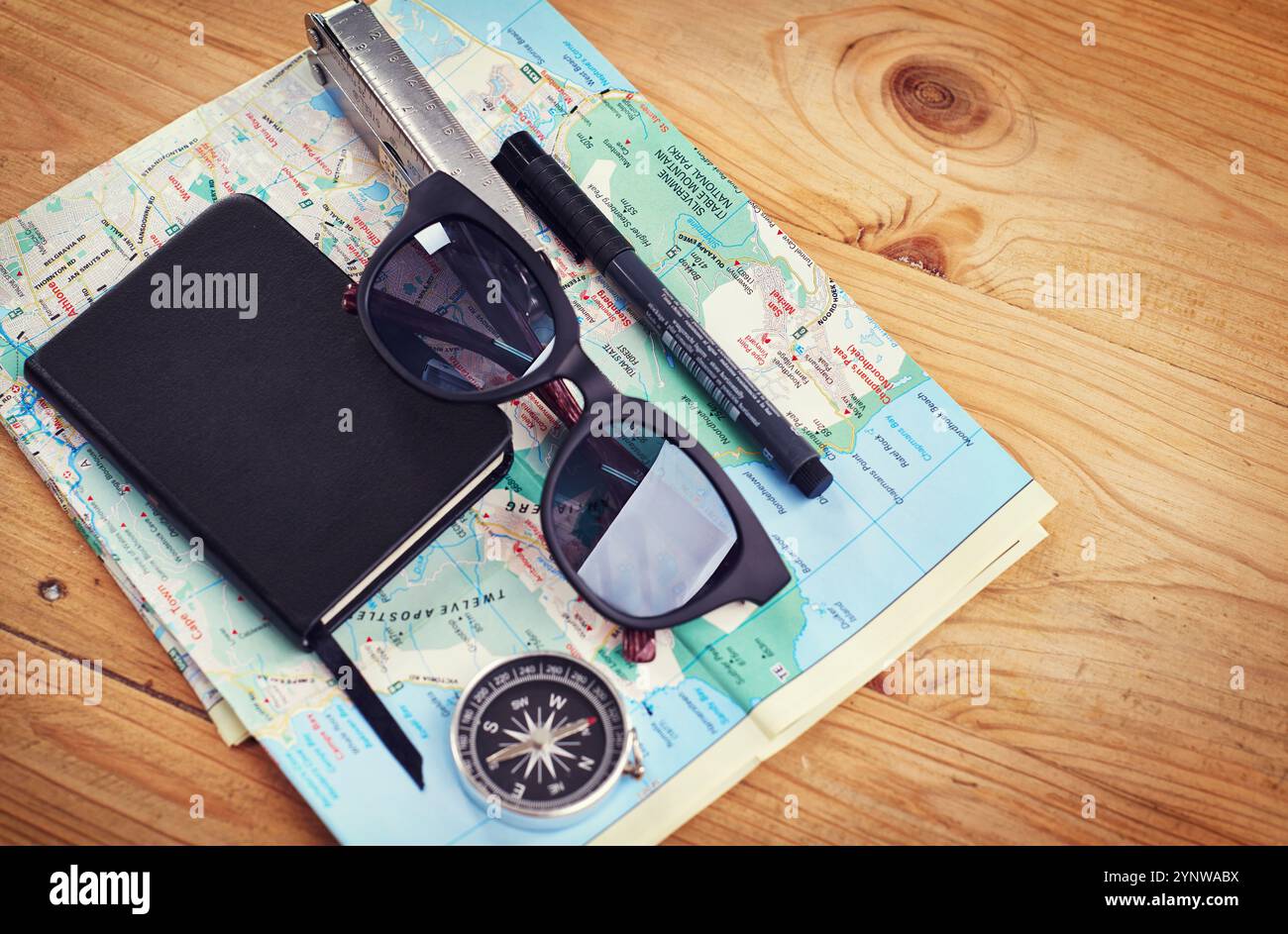 Sunglasses, travel and notebook with compass on map for itinerary ...