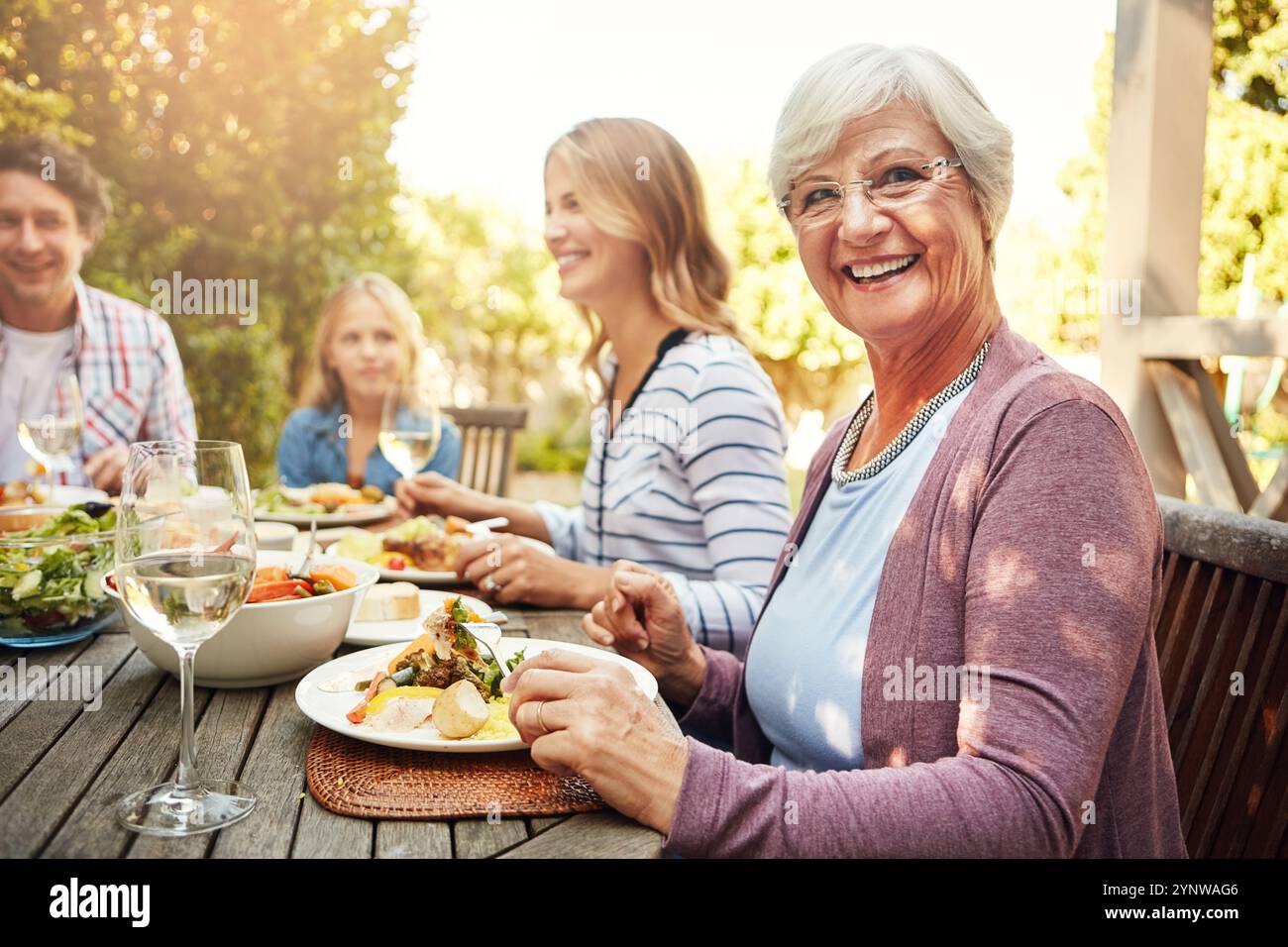 Garden, lunch and portrait of grandma with family for brunch, food and ...