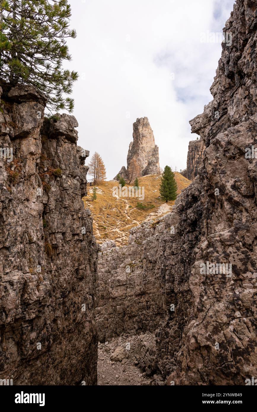 Stone walkway with a rock tower in the background, seen in the Dolomite ...