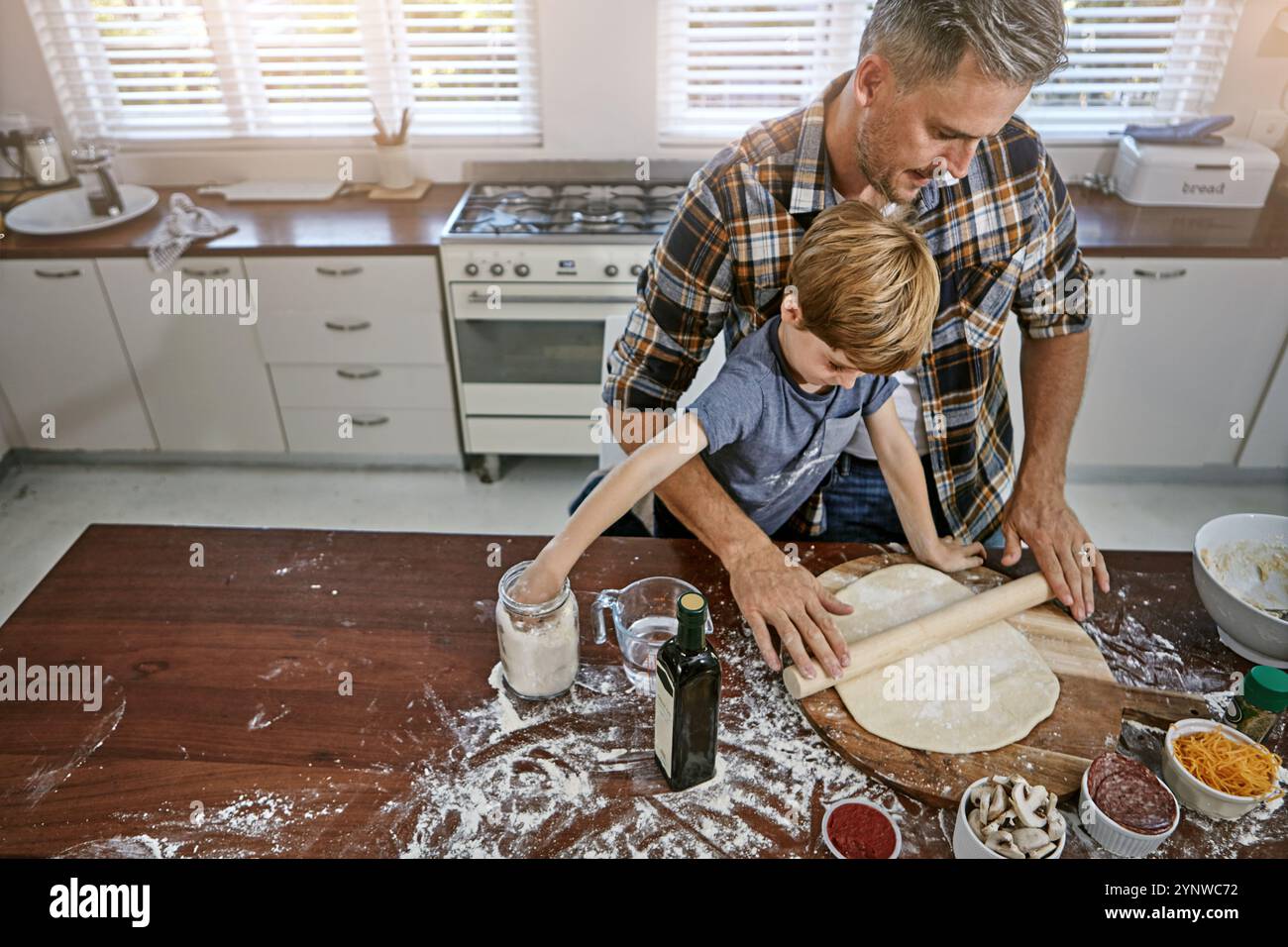 Above father, son and cooking help in kitchen for teaching with pizza ...