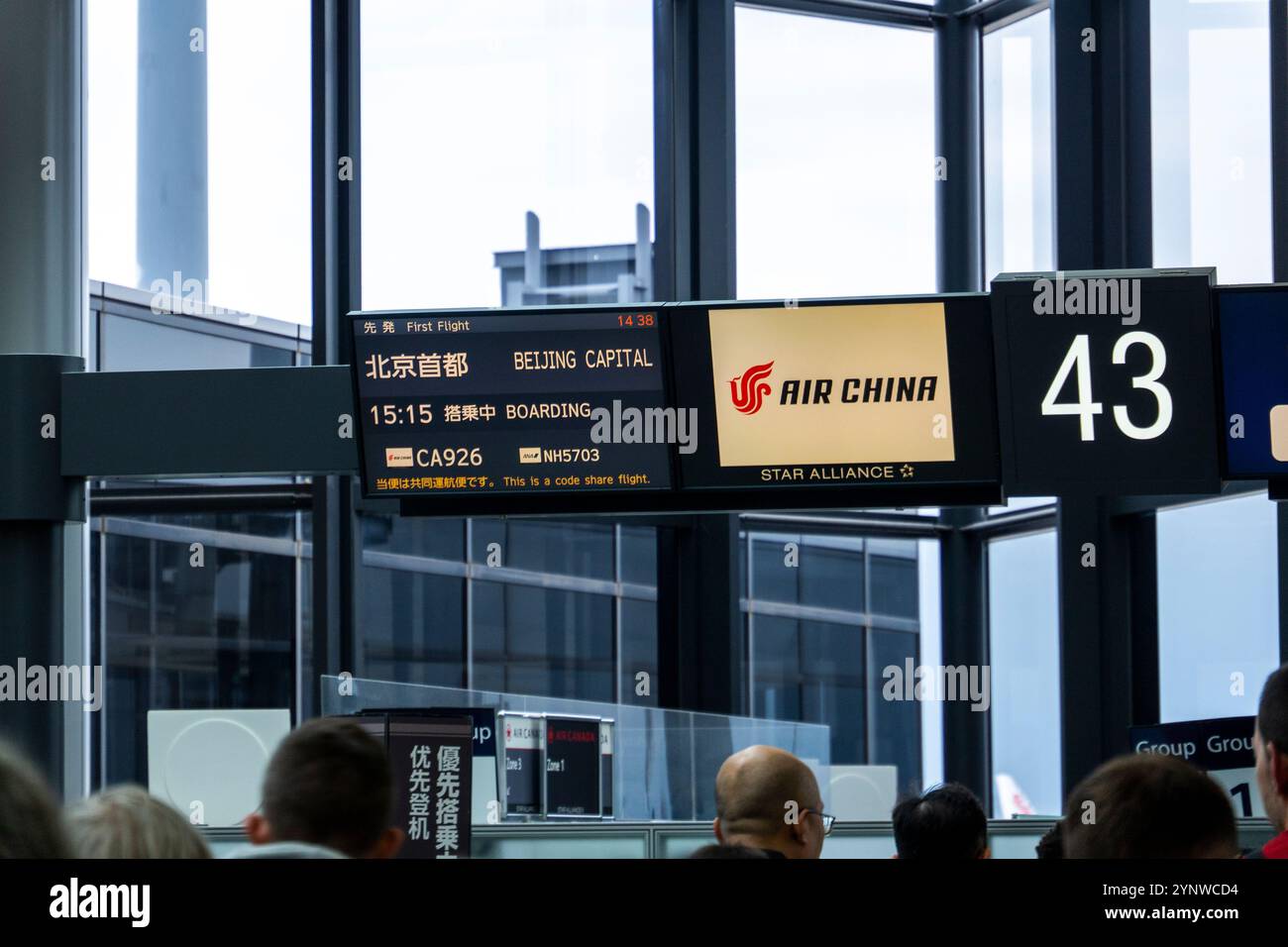 Flight information display at airport showing boarding for Beijing ...