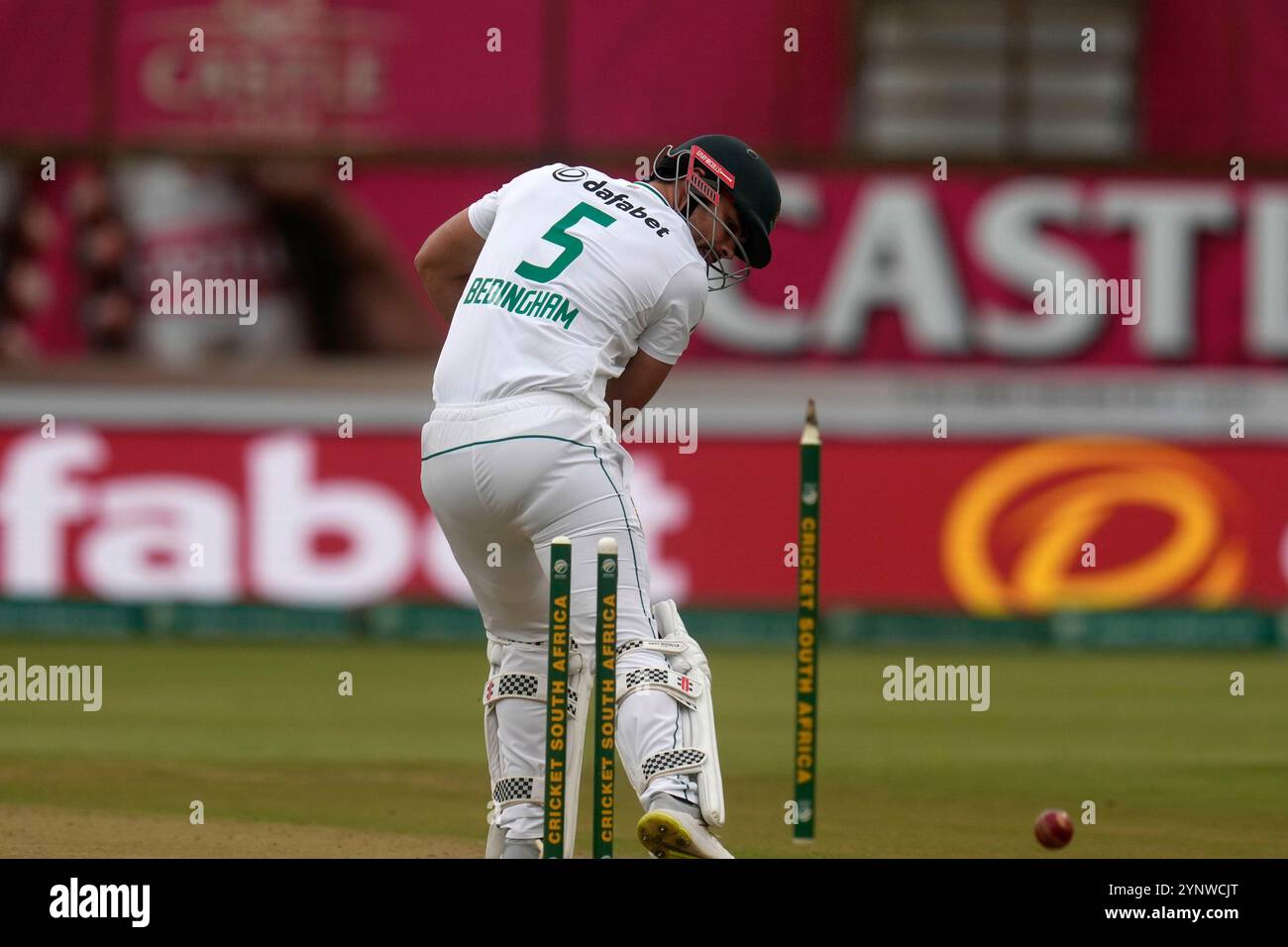 South Africa's David Bedingham watches on stumps flying after bowled by ...