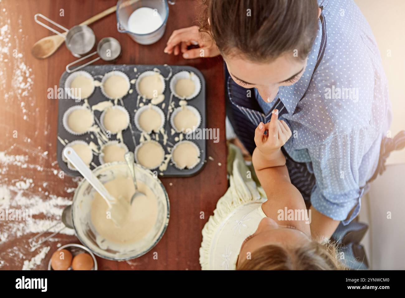 Child, playing or baking with mom, top view and flour for bonding or ...