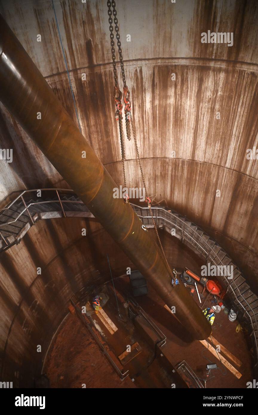 27 November 2024, Hamburg: The pipe section is held vertically in the ...