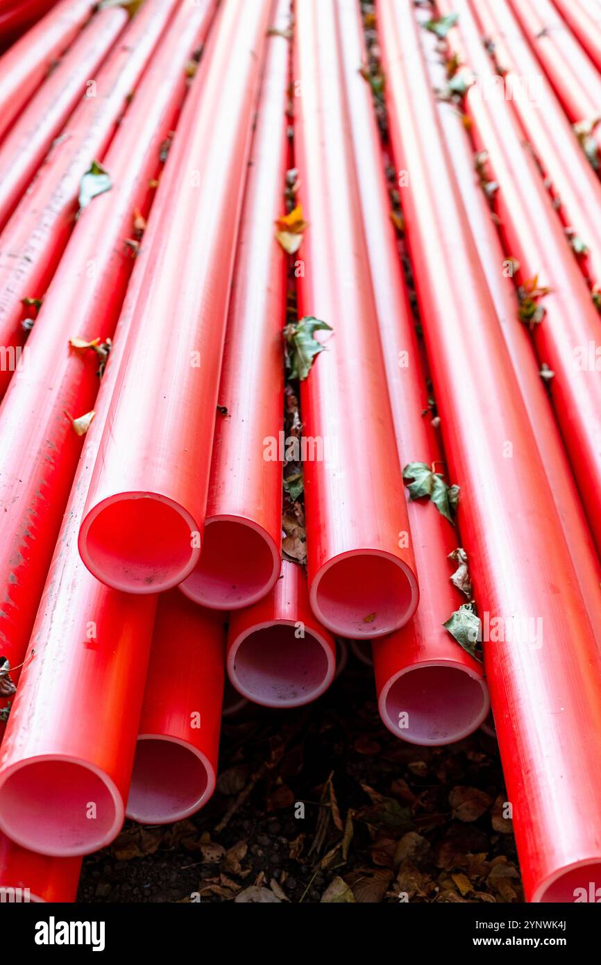 pile of new red plastic conduit pipes for underground electrical wiring ...
