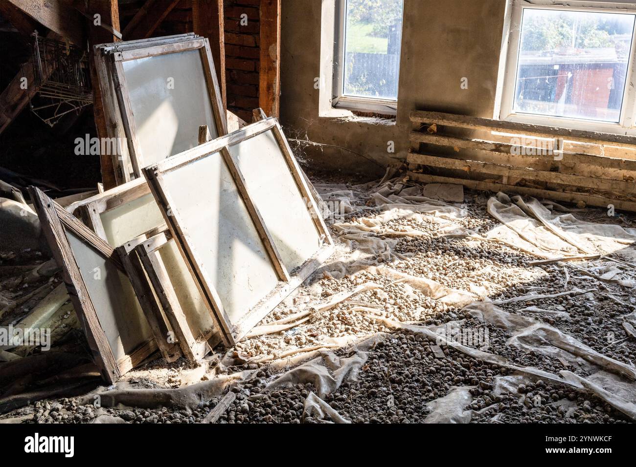 removed old glass and wooden window frames in attic of village house ...