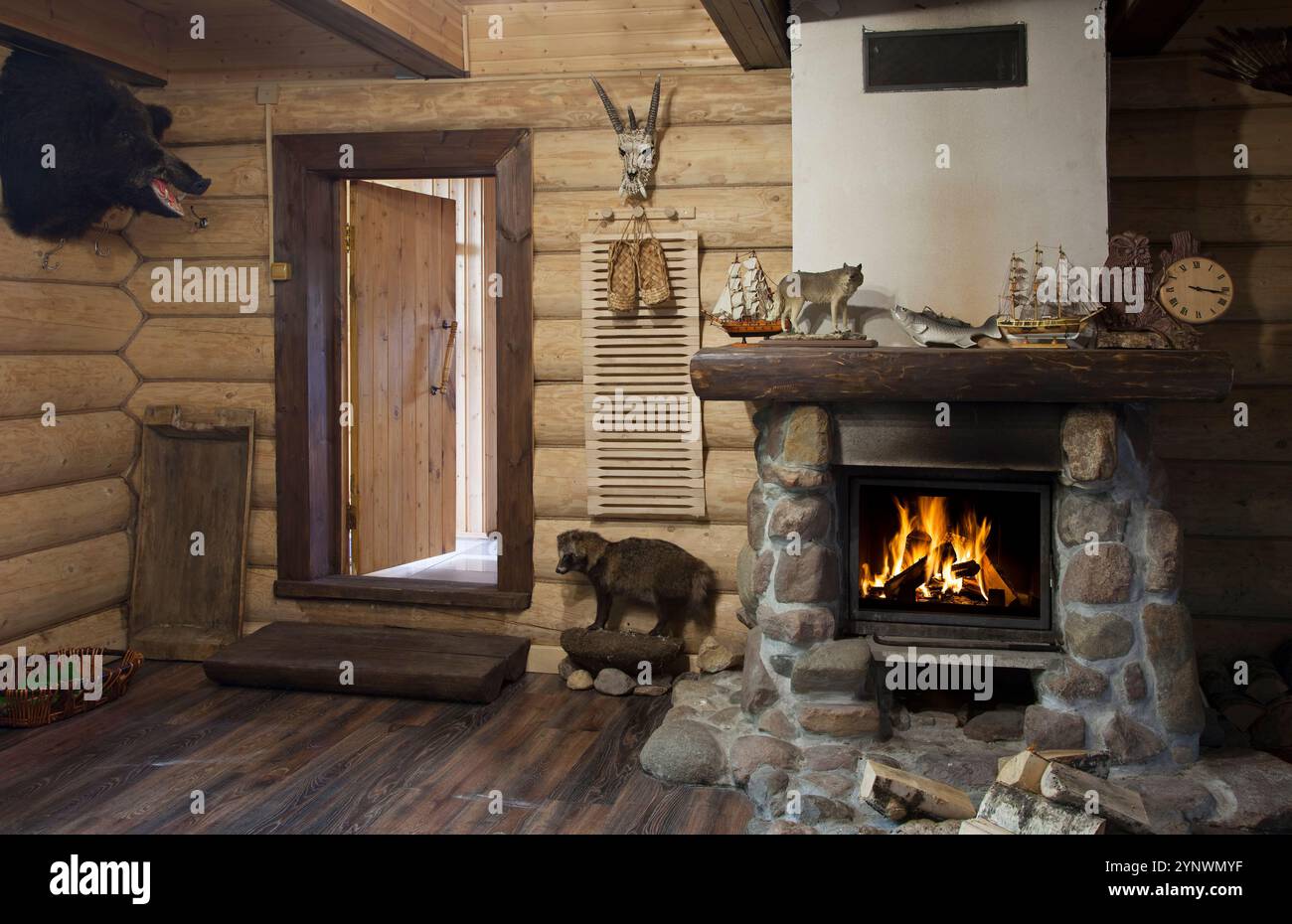 The interior of the hunter's house with burning fireplace and stuffed ...