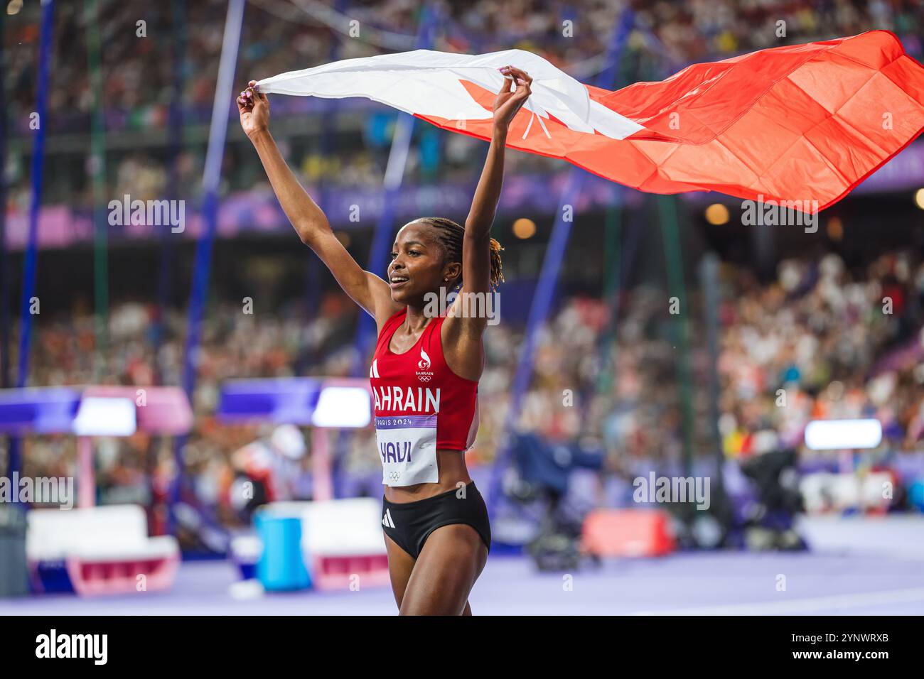 Winfred Yavi celebrating her medal with her country's flag at the Paris ...