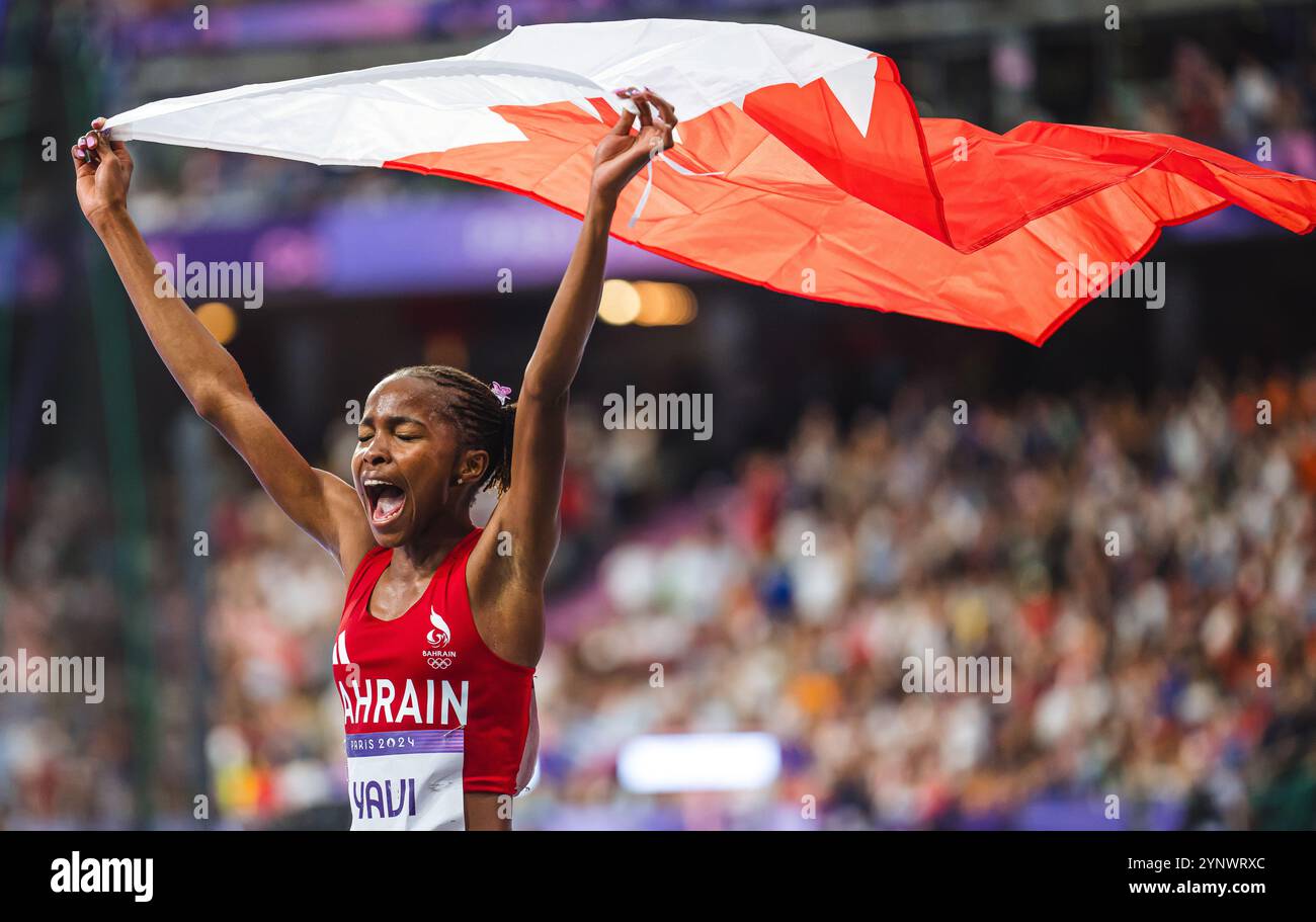 Winfred Yavi celebrating her medal with her country's flag at the Paris ...