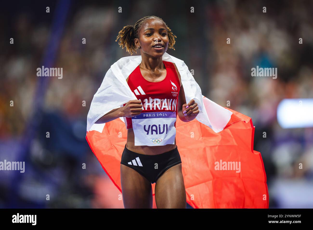 Winfred Yavi celebrating her medal with her country's flag at the Paris ...