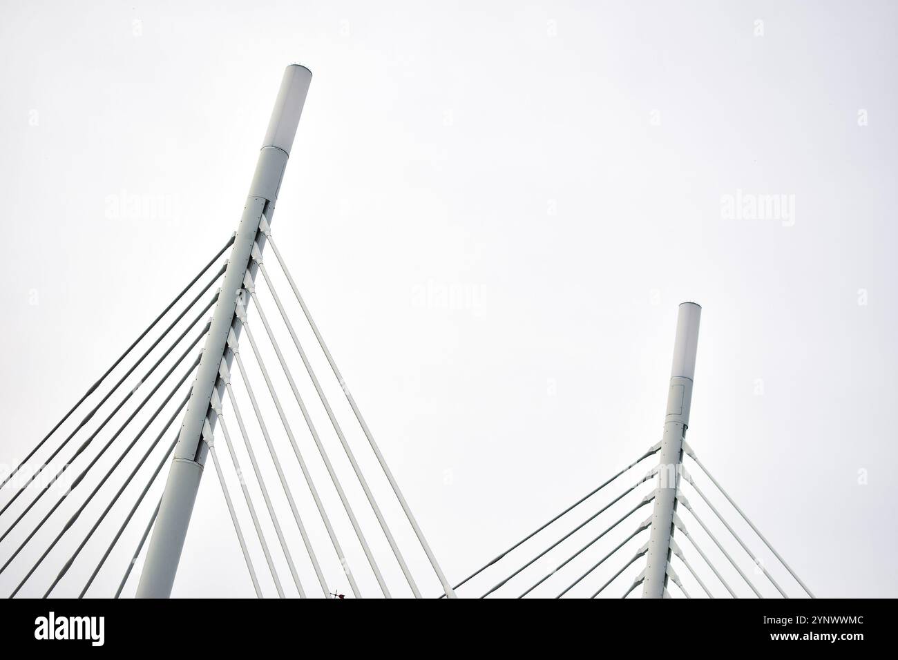 White supporting bridge poles with steel cables Stock Photo - Alamy
