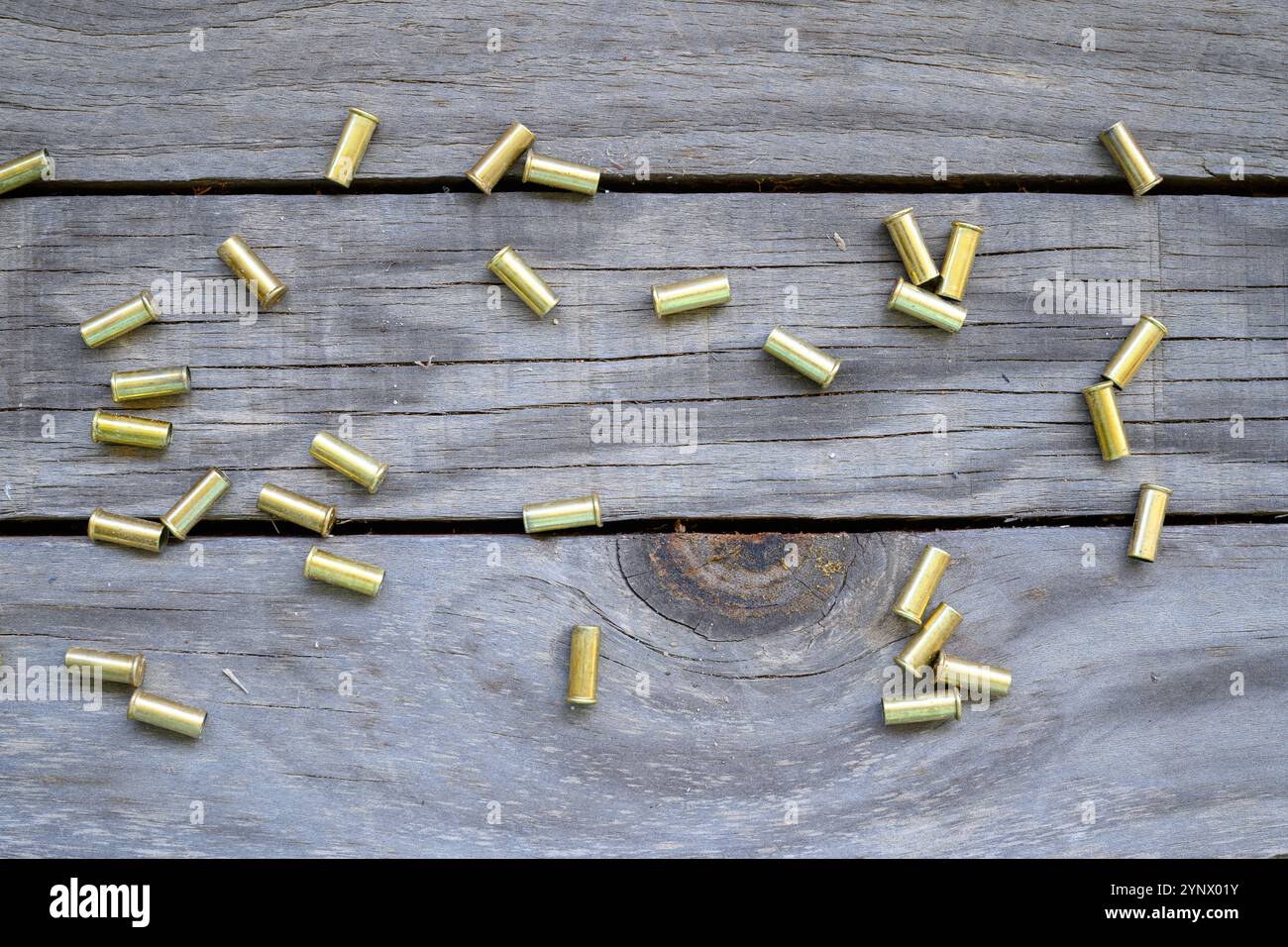 used spent bullet casings bullets on timber wooden bench, background ...