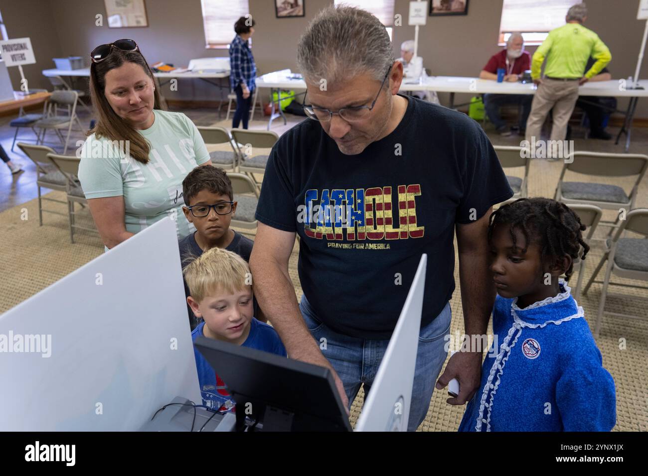 Mike Young, joined by his wife Erin Young, left, and their three ...