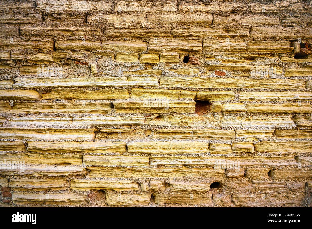 Granada, Spain - July 17, 2024: Ancient layered stone wall in the ...