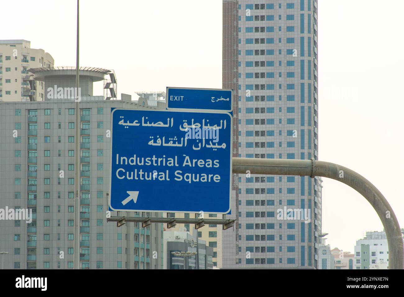 Directional road signs in Arabic and English on the bridge in Sharjah ...
