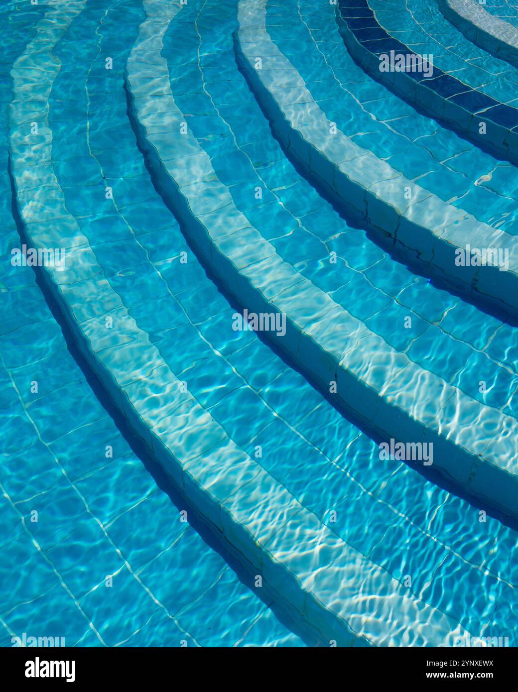 Swimming pool background with distorted tiles and stairs below water ...