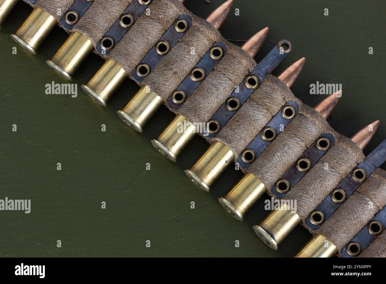 Machine Gun Ammo Belt with Ammunition on green ammo box background ...