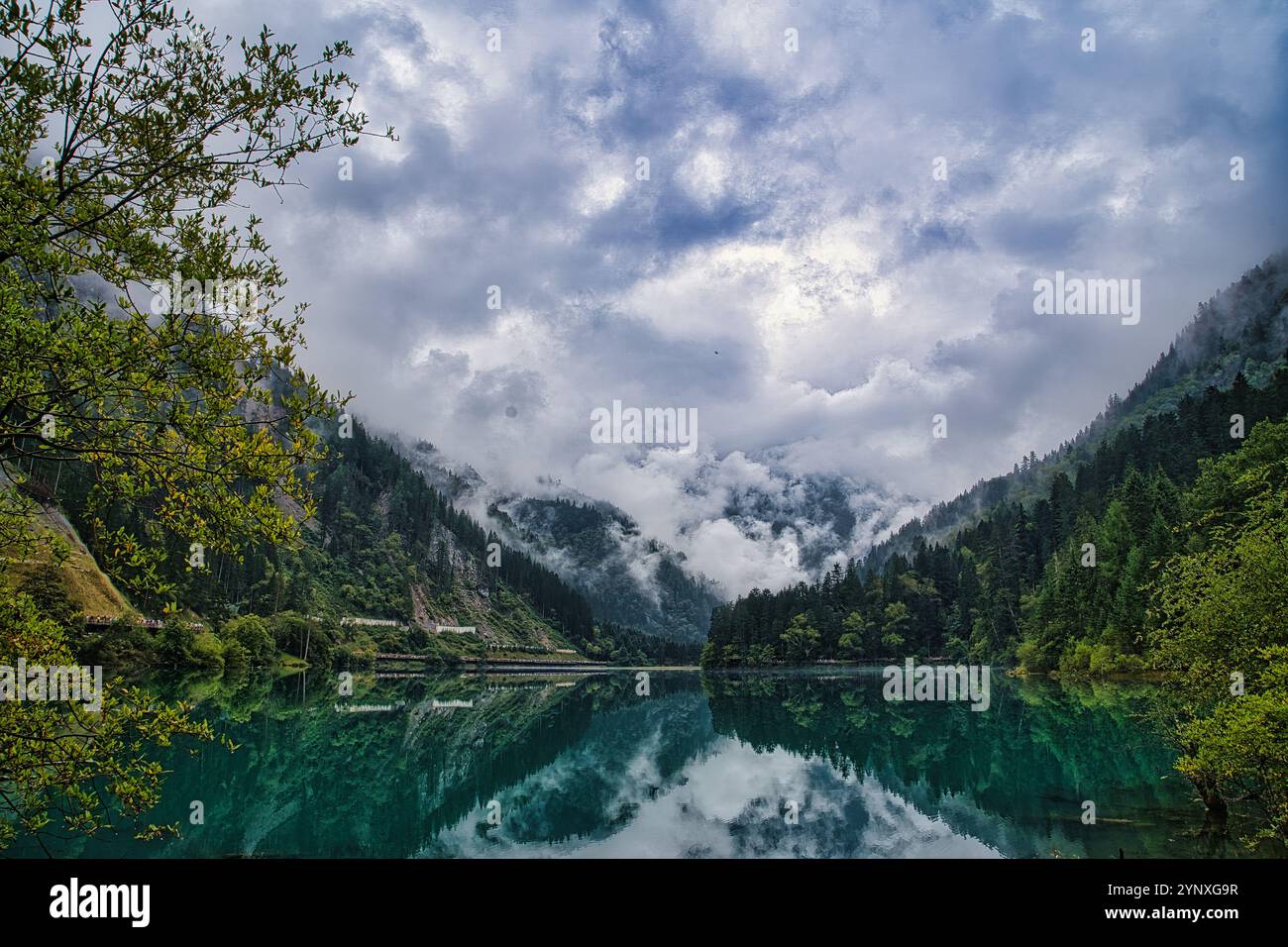 A mesmerizing alpine scene where a crystal-clear lake mirrors the ...