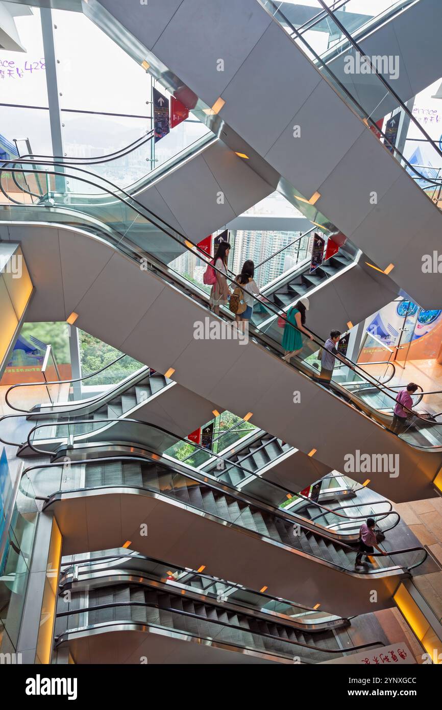 Multi-level escalators in a modern shopping mall with dynamic ...
